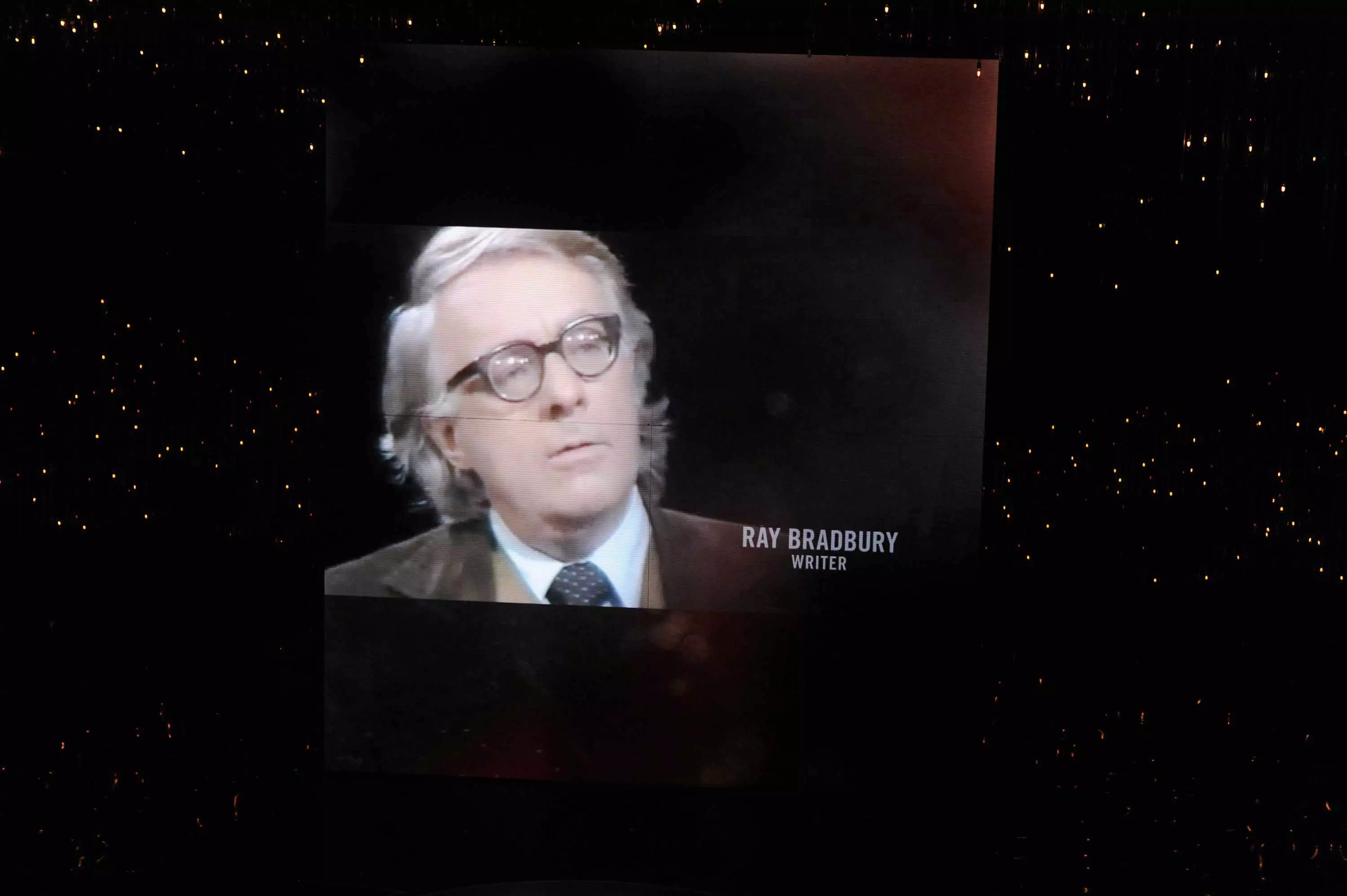 Foto de Ray Bradbury projekciita kontraŭ stela fono