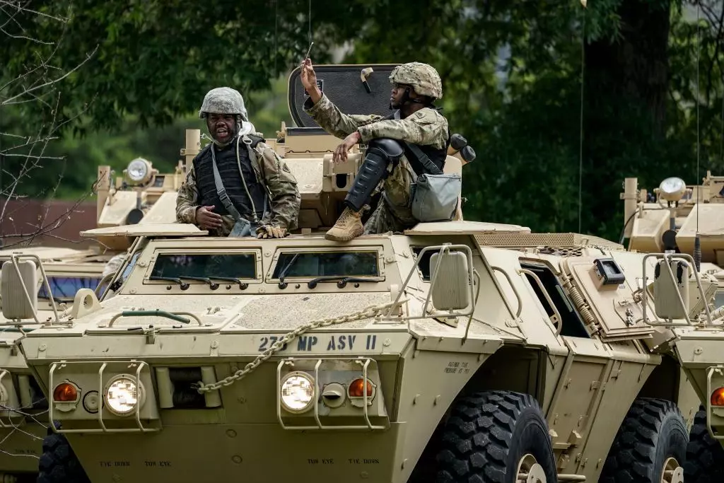 Militaire politie van de Nationale Garde wacht op vertrek naar de stad in gepantserde personeelswagens op het Joint Force-hoofdkwartier van de Nationale Garde van DC op 2 juni 2020 in Washington, DC.