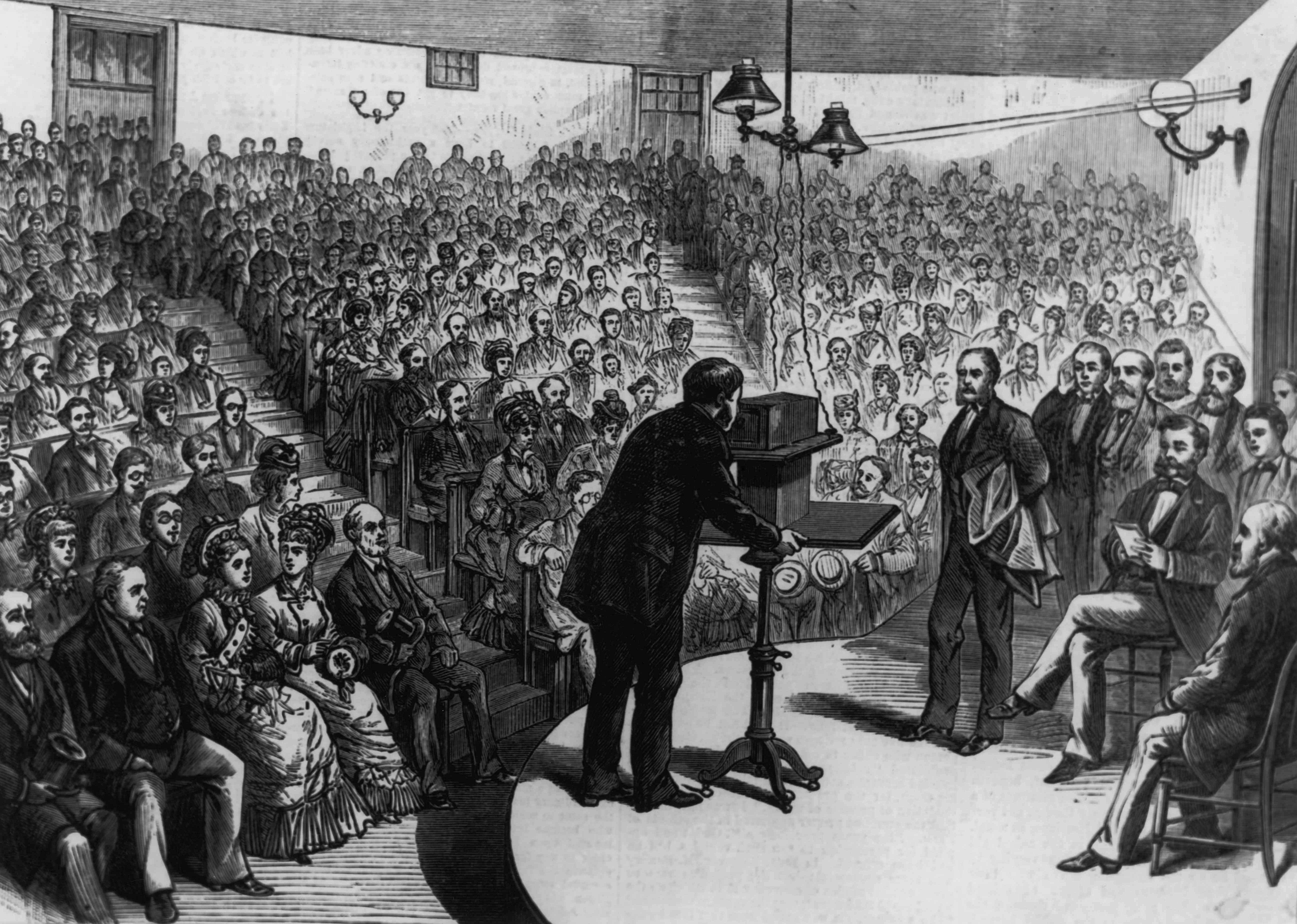 Малюнак Аляксандра Грэма Бэла, які дэманструе свой тэлефон у Ліцэйскай зале ў Салеме, штат Масачусэтс, 15 сакавіка 1877 г.